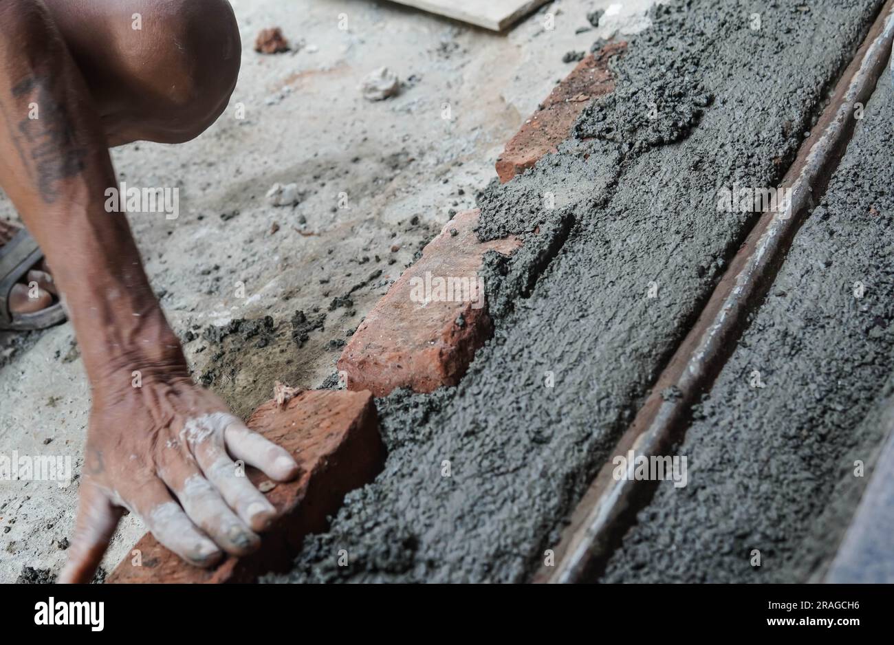 Worker or mason hands laying bricks close up. Bricklayer works at brick ...