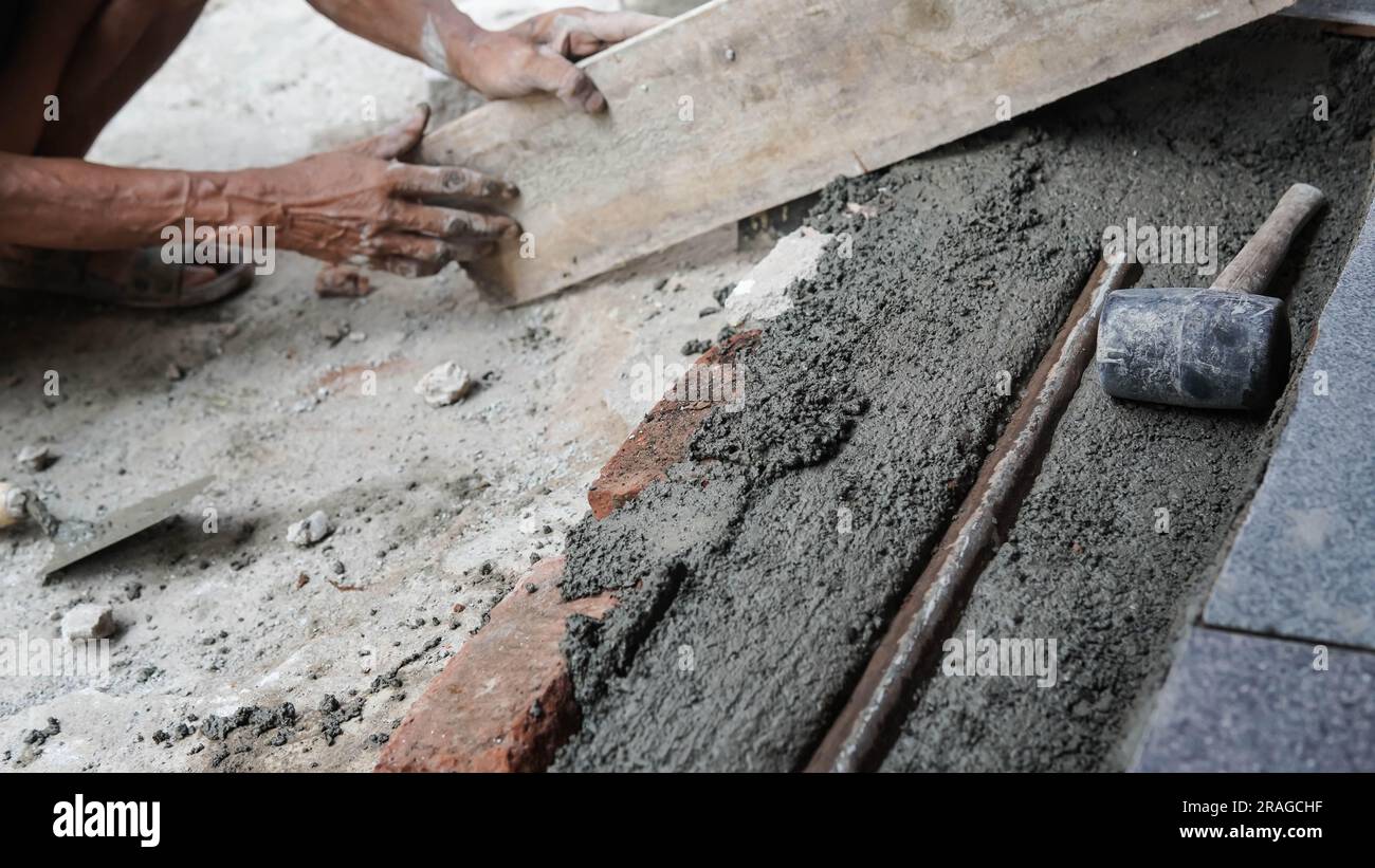 Worker or mason hands laying bricks close up. Bricklayer works at brick ...