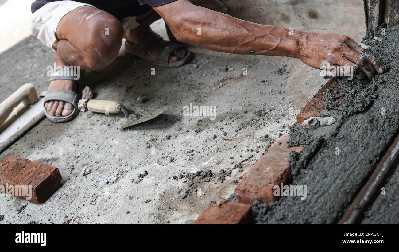 Worker or mason hands laying bricks close up. Bricklayer works at brick ...