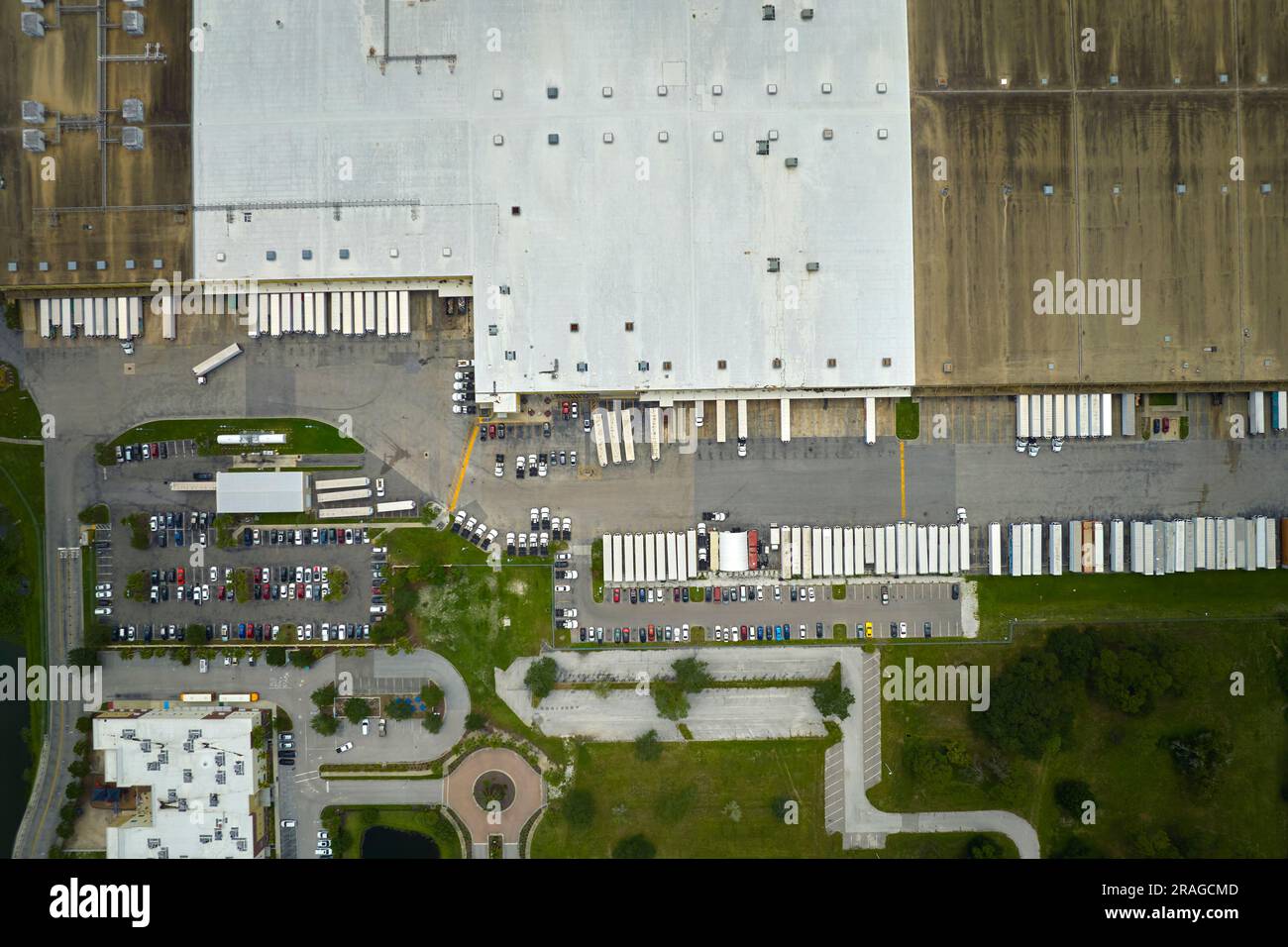 Aerial view of large commercial distribution center with many trucks ...