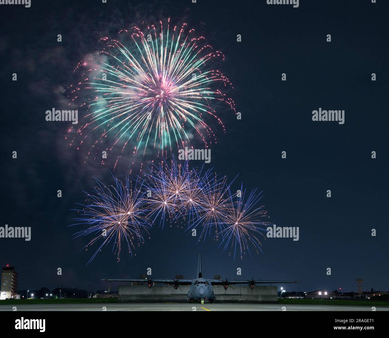 Fireworks explode behind a C-130J Super Hercules assigned to the 36th ...