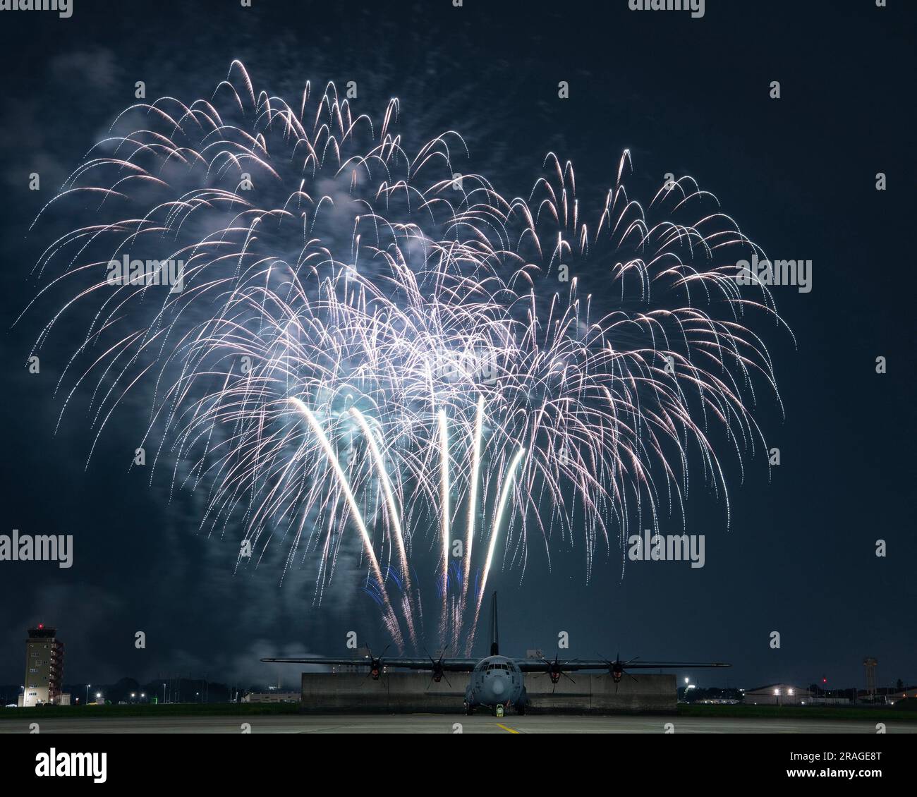 Fireworks explode behind a C-130J Super Hercules assigned to the 36th ...