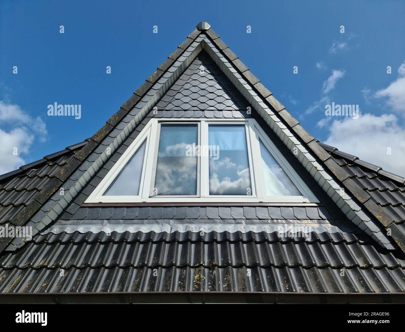 Open roof window in velux style with black roof tiles Stock Photo - Alamy