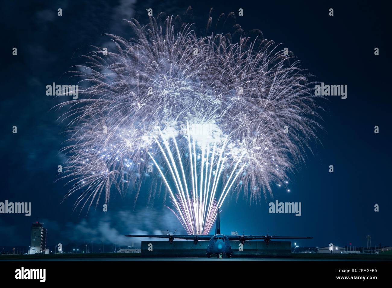 Fireworks explode behind a C-130J Super Hercules assigned to the 36th ...