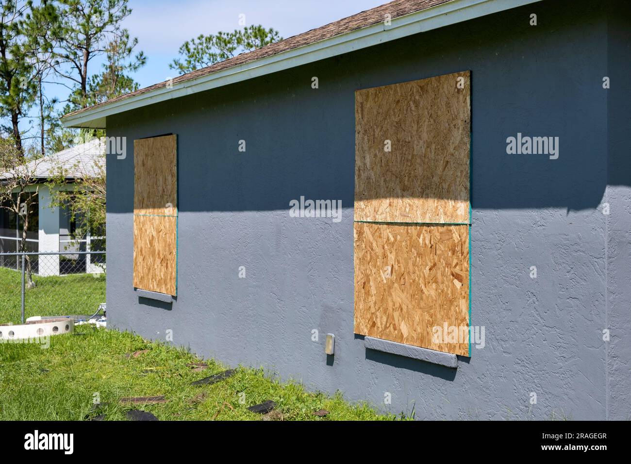 Boarded up windows with plywood storm shutters for hurricane protection ...