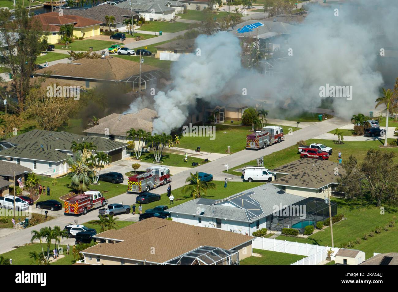 Burning residential house on fire with smoke and flames and ...