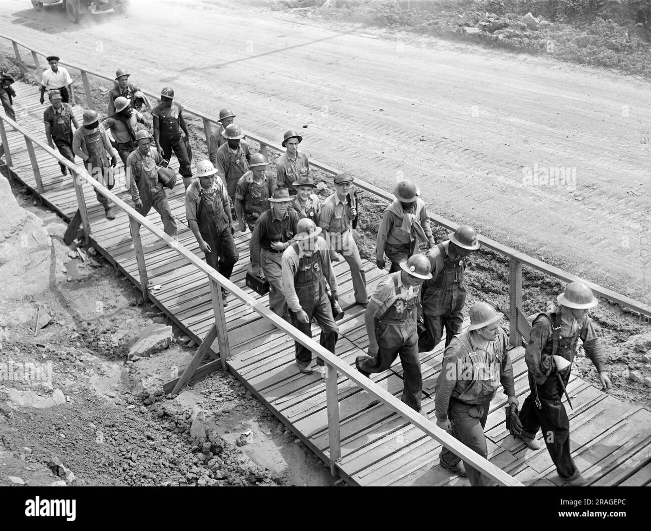 Worker's changing shifts during construction of Douglas Dam, a ...