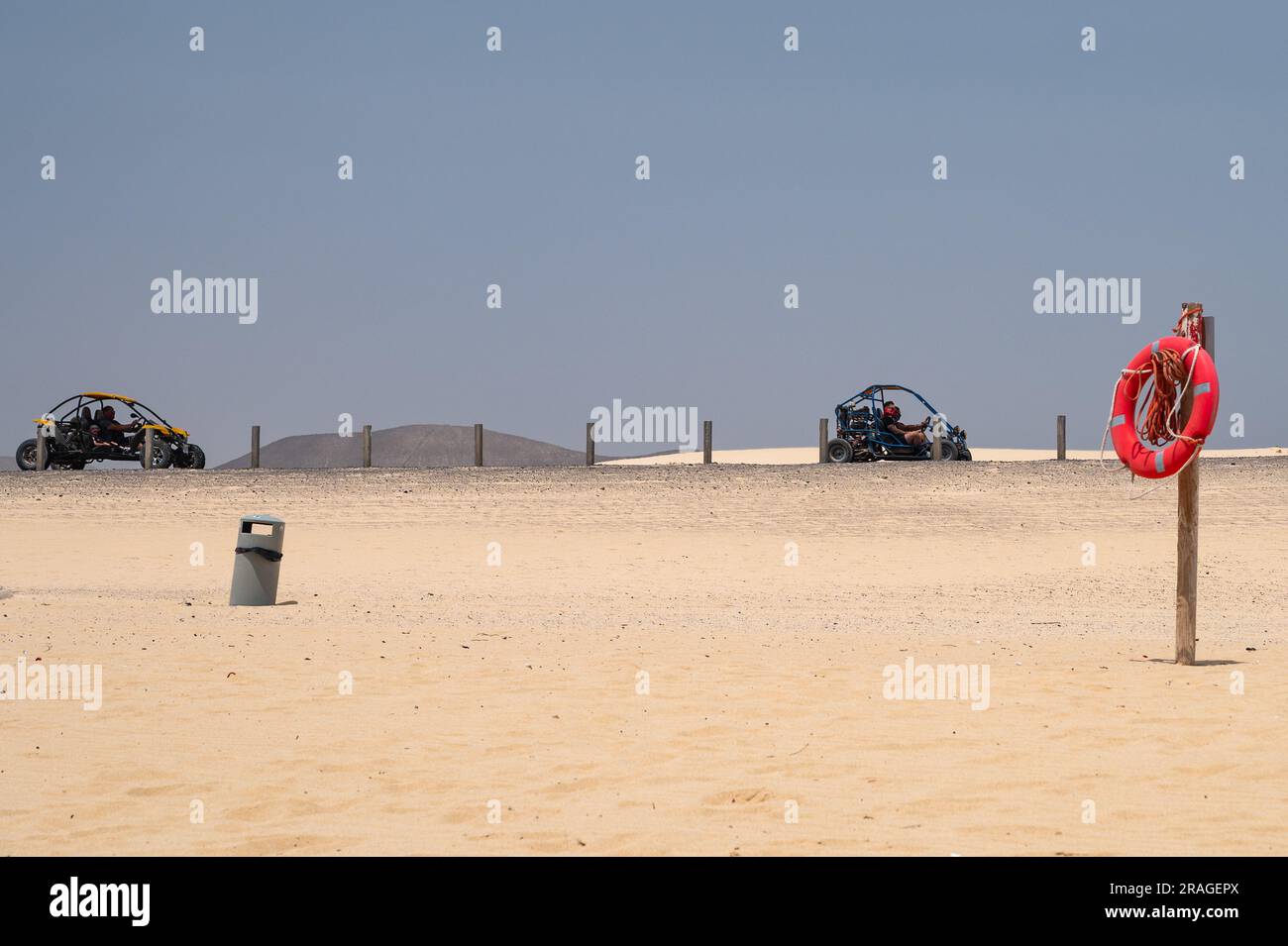 Dune buggies are seen driving during a hot summer day passing through ...