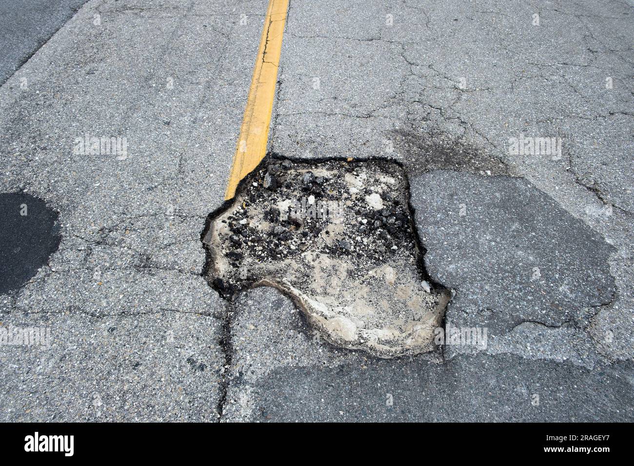 Damaged asphalt road with deep pothole on american highway surface ...