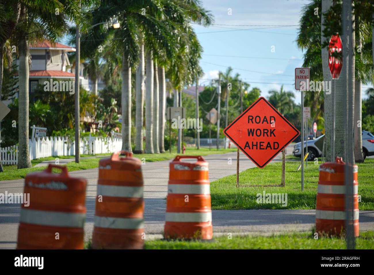 Road work ahead sign and barrier cones on street site as warning to ...