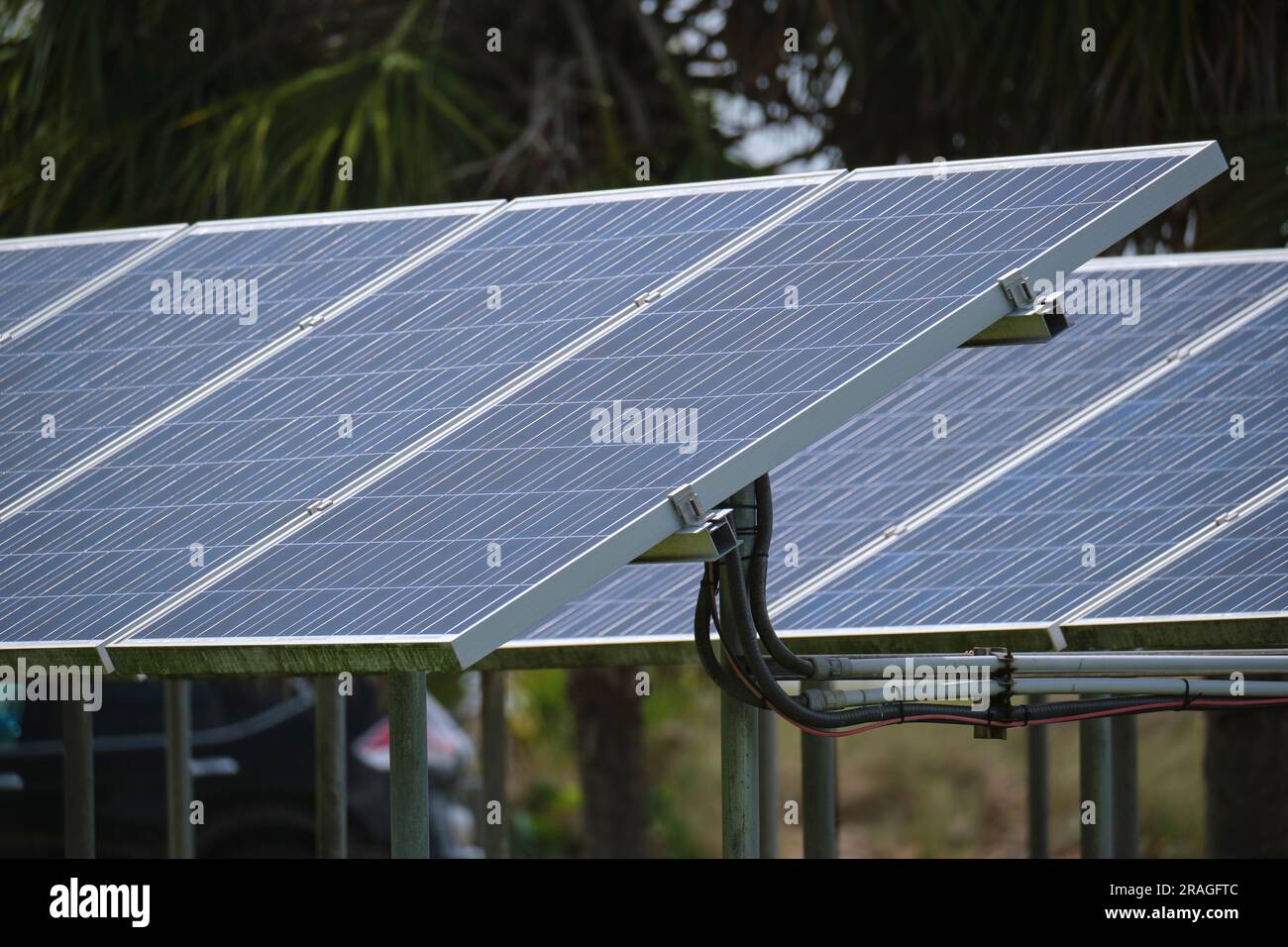 Solar panels installed on stand frame near parking lot for effective ...