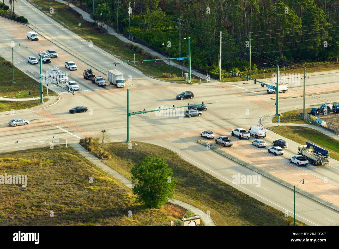 Top view of wide road with moving cars at intersection with traffic ...