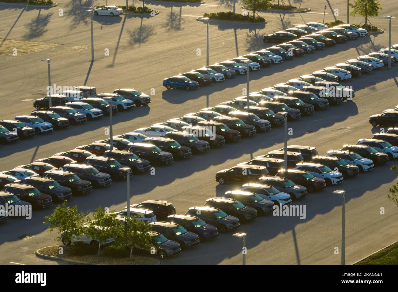 View from above of dealers outdoor parking lot with many brand new cars ...