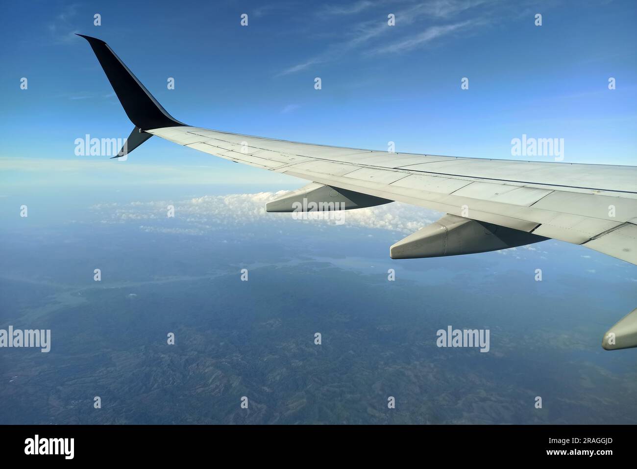 View through airplane window of commercial jet plane wing flying high ...