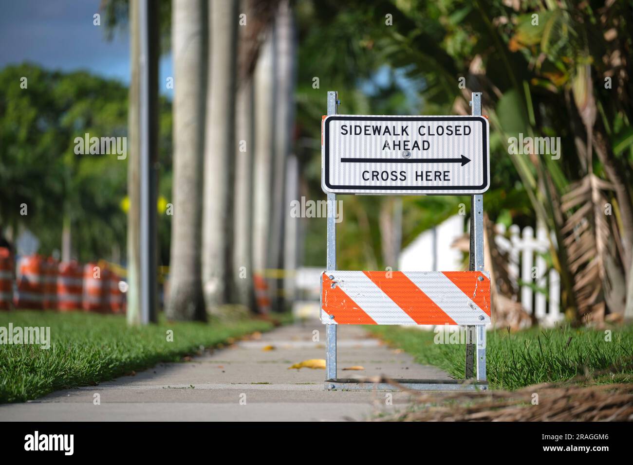 Warning sign that sidewalk is closed at street construction site ...