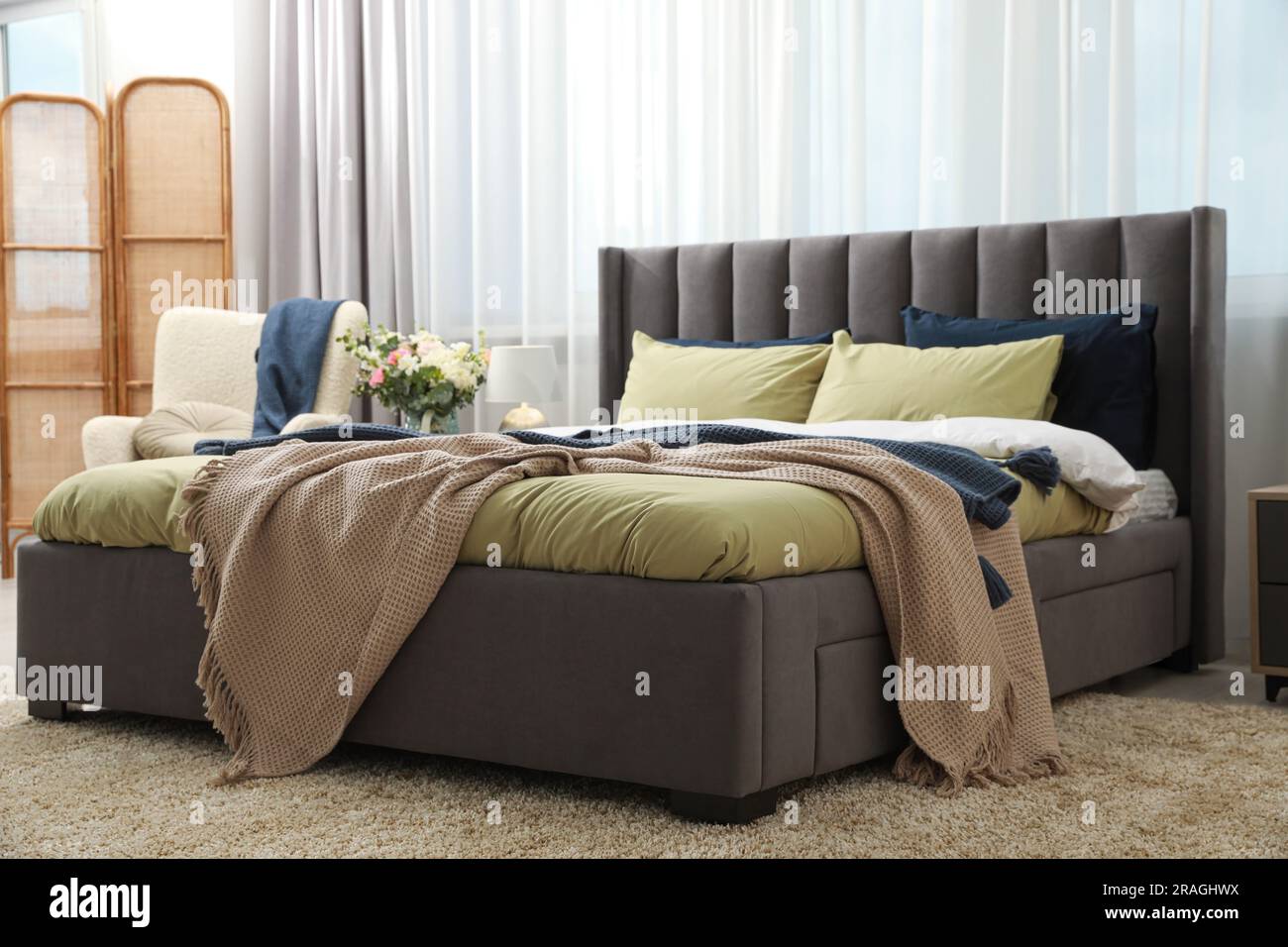 Stylish bedroom interior with large comfortable bed Stock Photo - Alamy