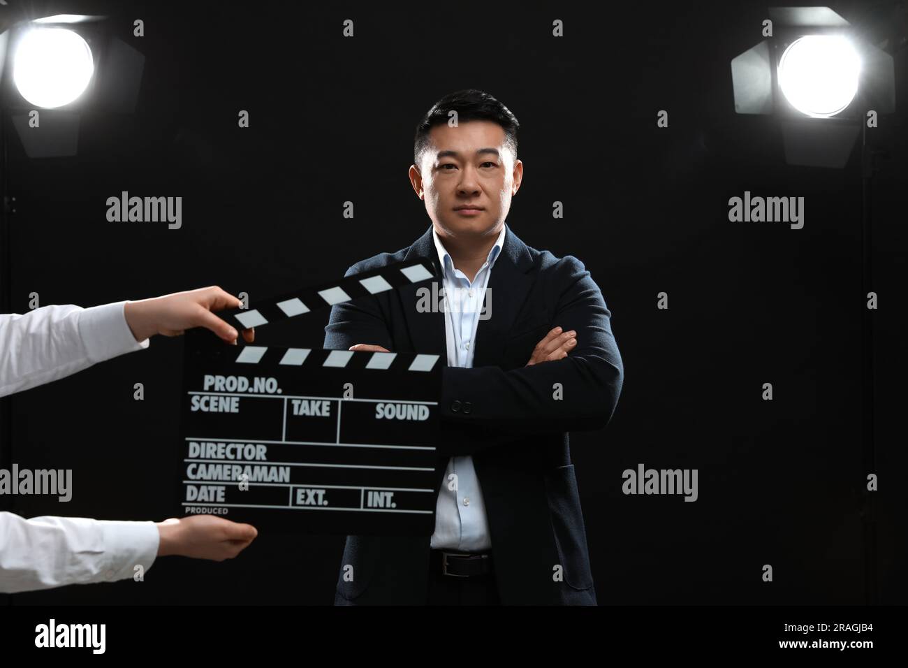 Asian actor performing while second assistant camera holding ...
