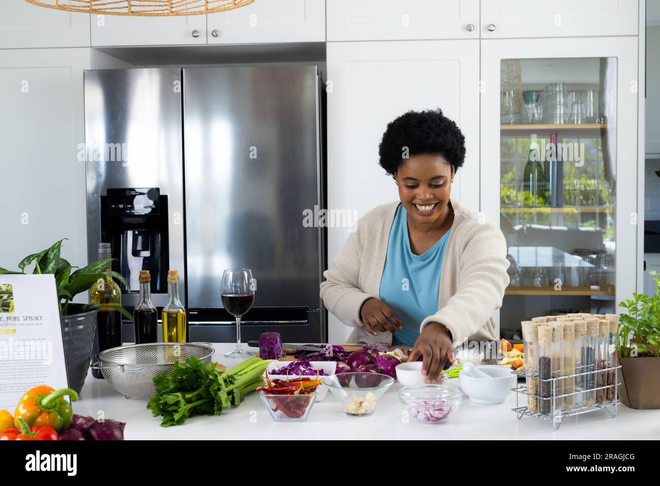 Happy plus size african american woman preparing meal in kitchen Stock ...