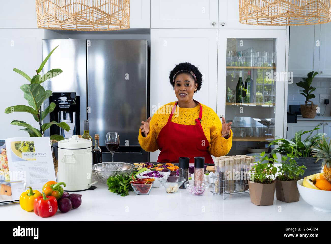 Happy plus size african american cooking vlogger in apron preparing ...
