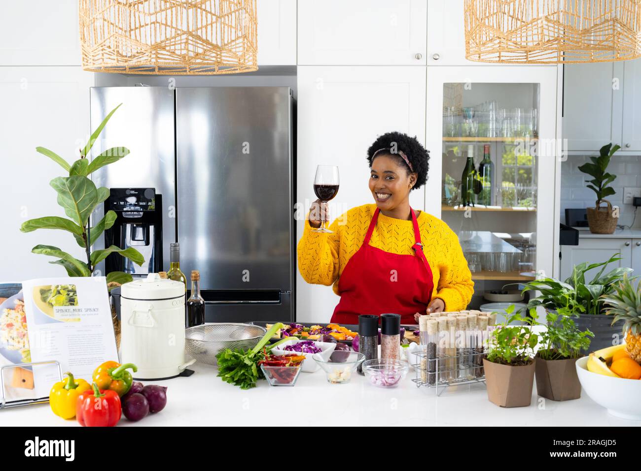 Happy plus size african american cooking vlogger in apron preparing ...