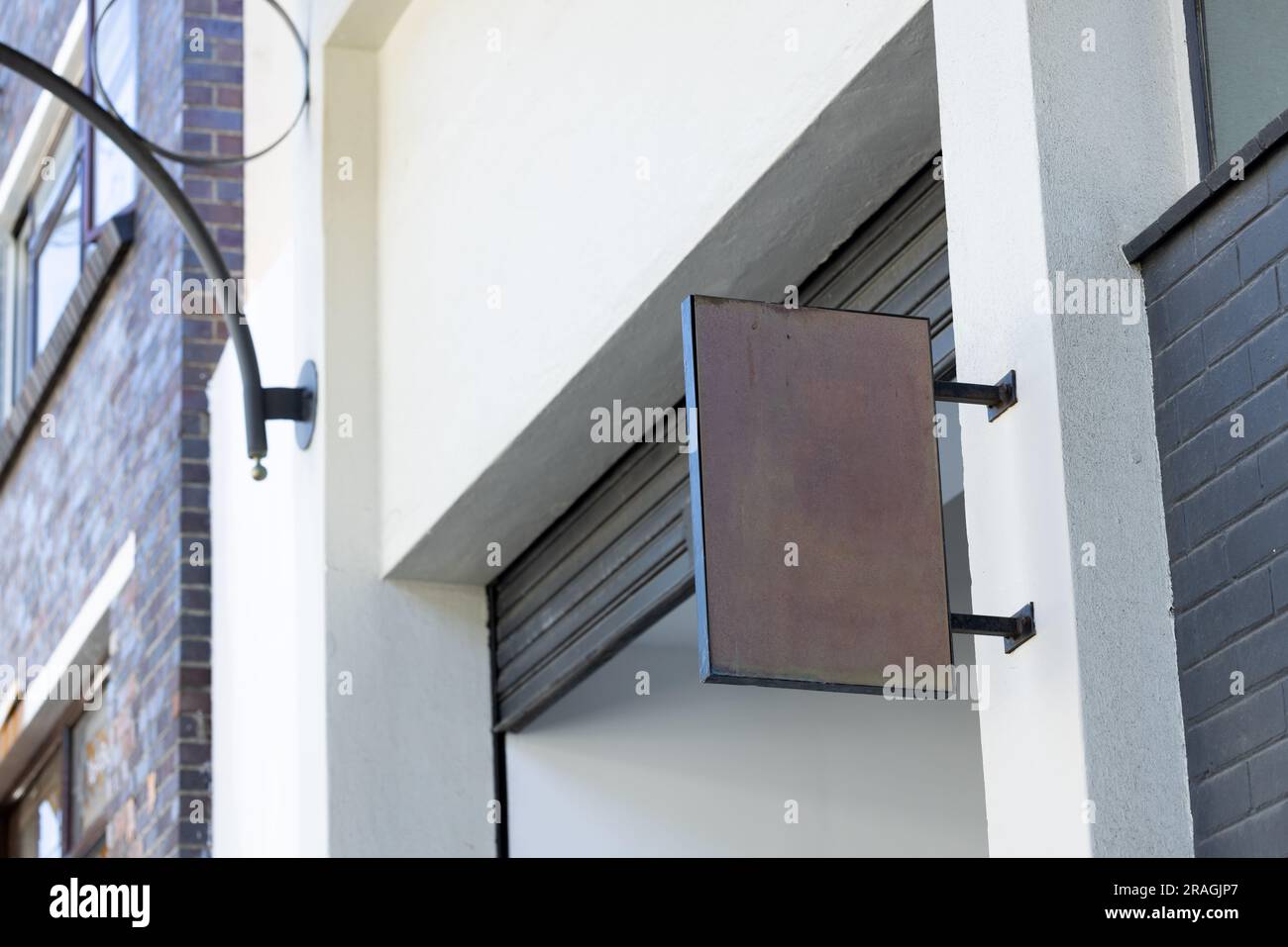 Blank sign fixed to building wall with copy space Stock Photo - Alamy
