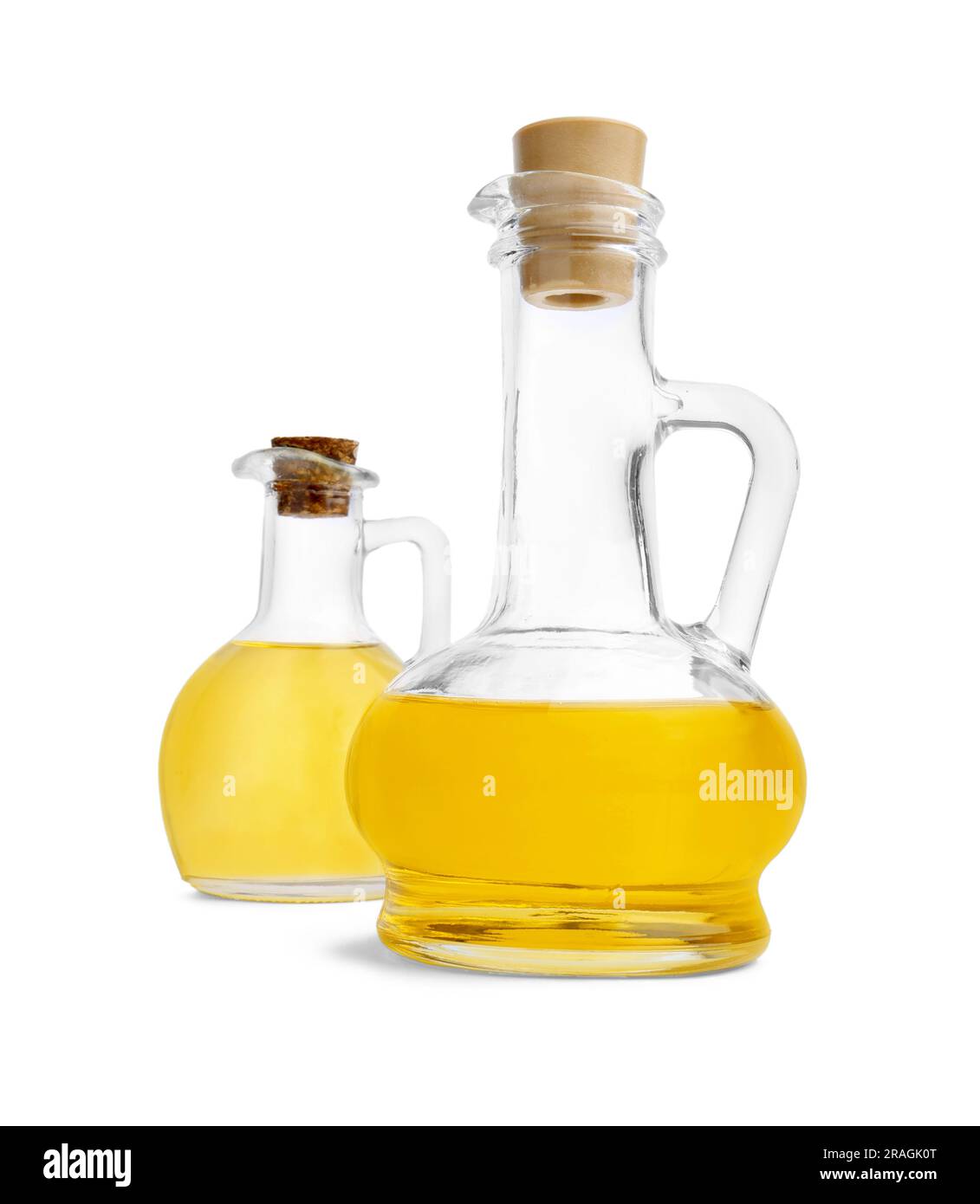 Glass jugs of cooking oil on white background Stock Photo - Alamy