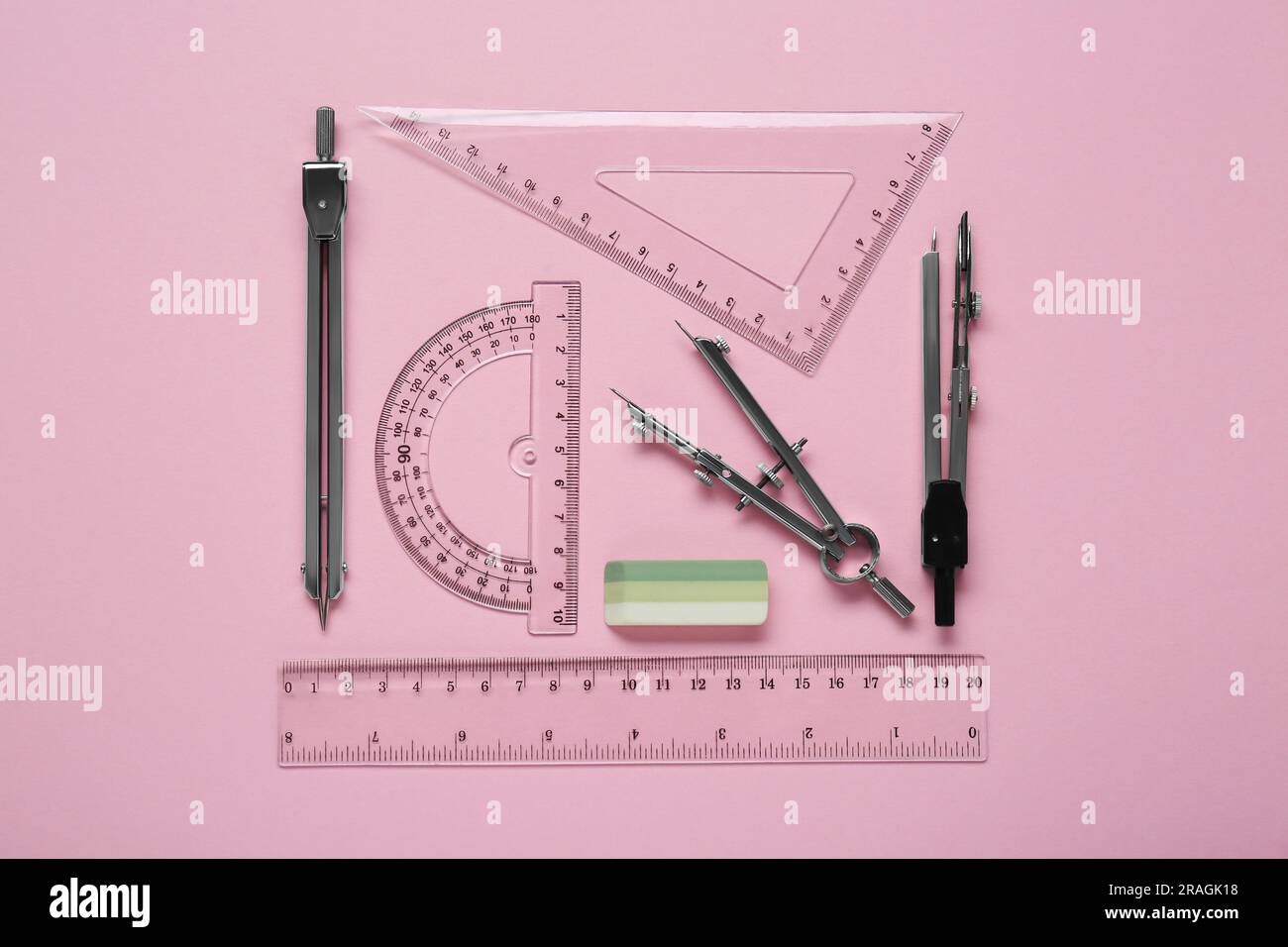 Flat lay composition with different rulers and stationery on pink ...