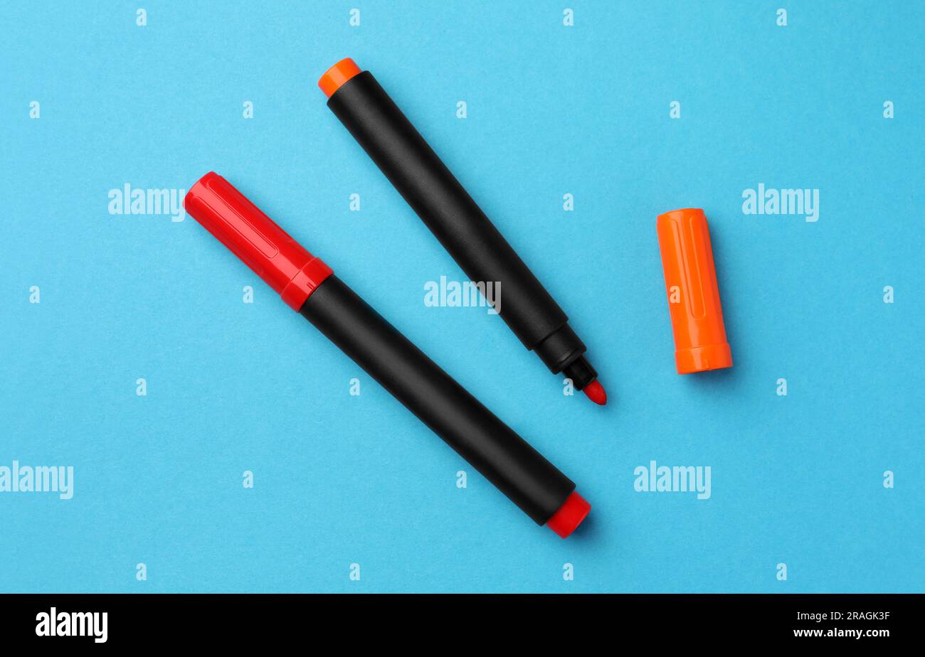 Bright color markers on light blue background, flat lay Stock Photo - Alamy
