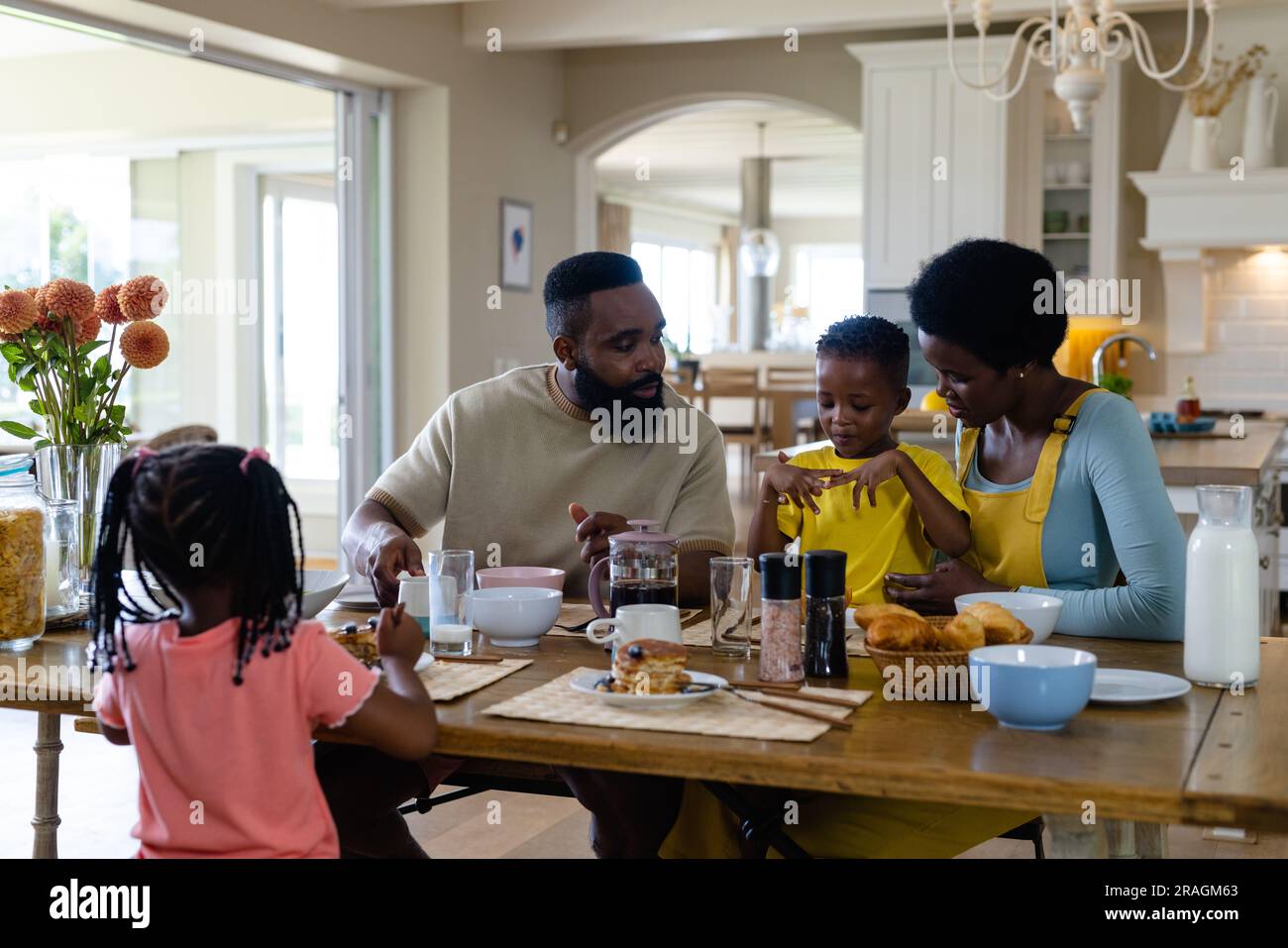 African american parents talking with children while having breakfast ...
