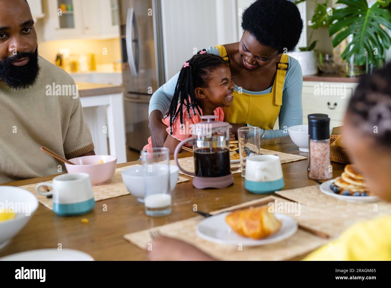 African american mother and father having breakfast with cheerful ...