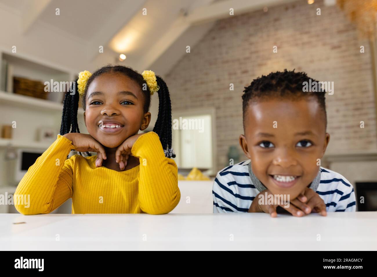 Happy african american sister and brother making video call at home ...