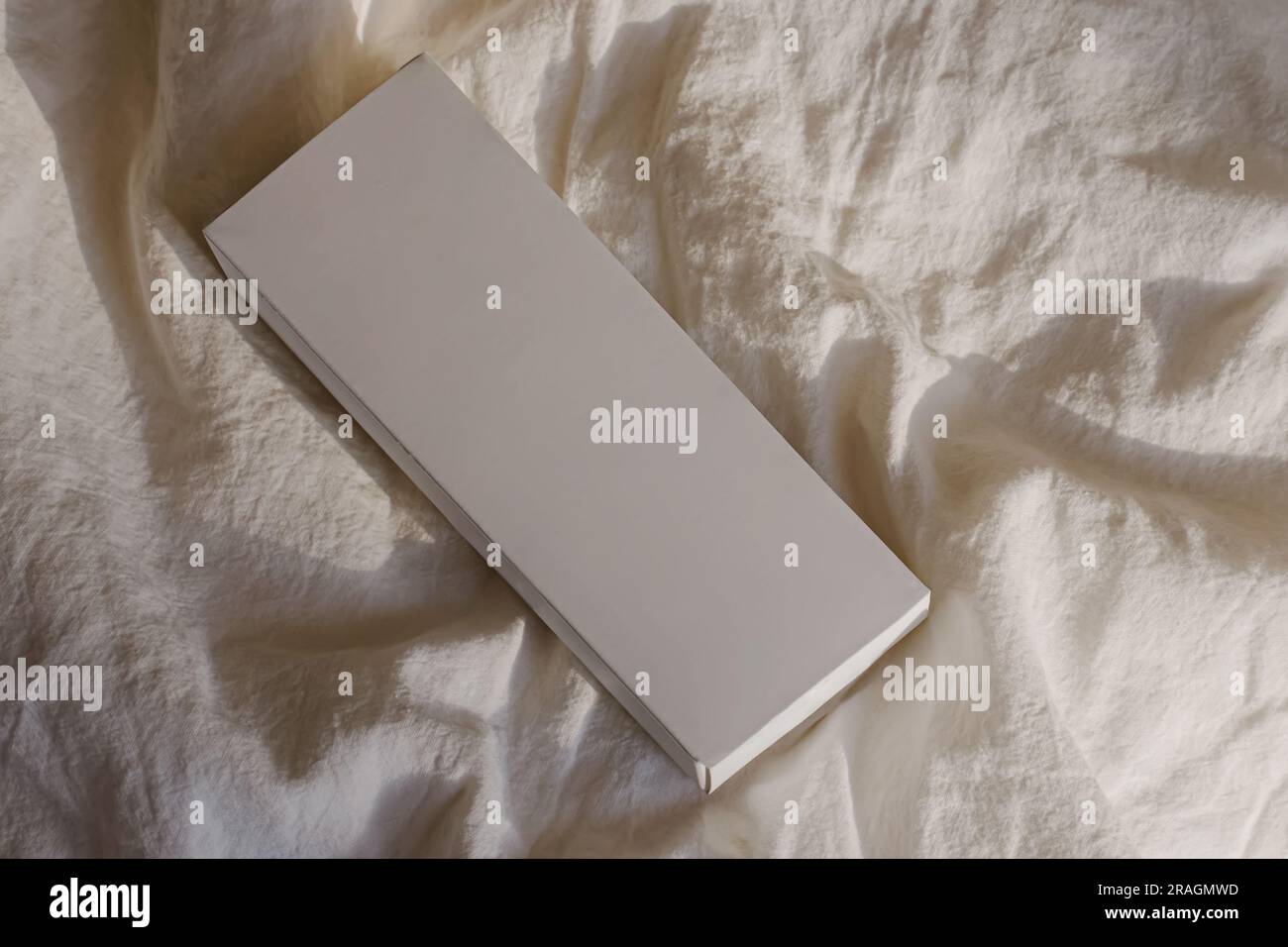 White box on the bed close-up, package mock-up, natural light Stock ...