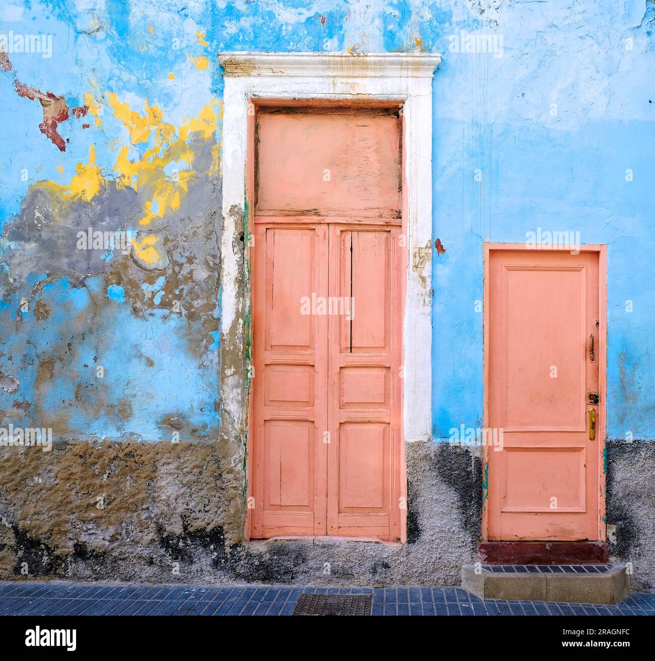 Pink doors, blue wall, pastel colours, Latino district Stock Photo - Alamy