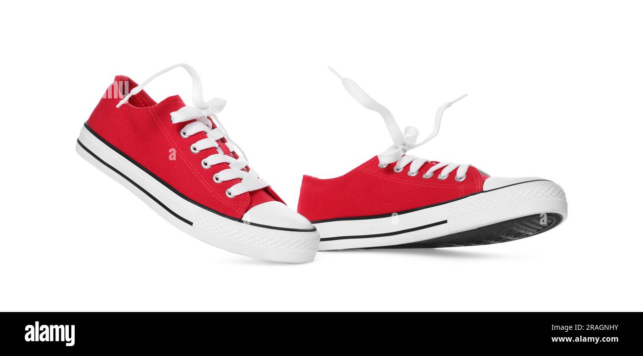 Pair of red classic old school sneakers on white background Stock Photo ...