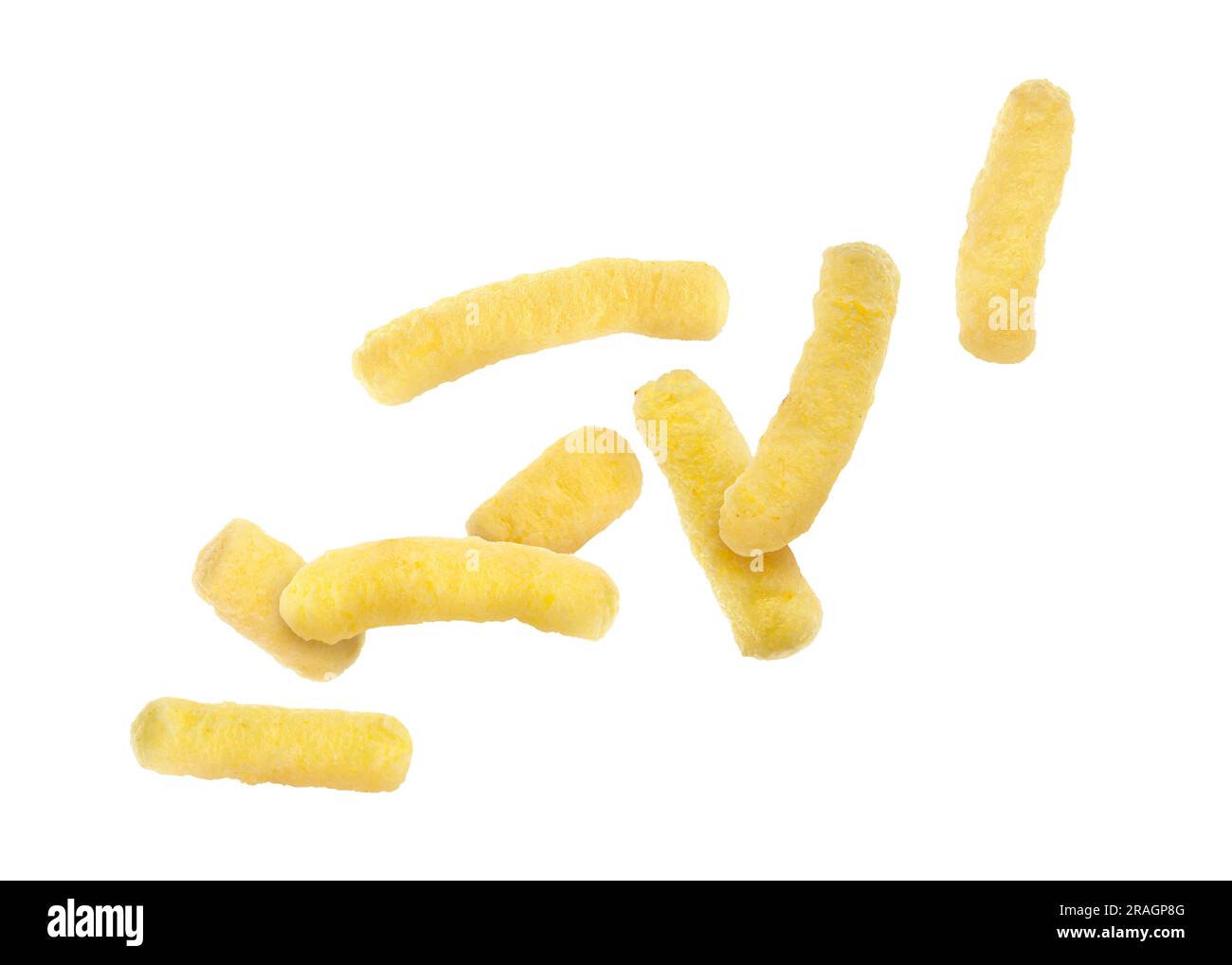 Many tasty corn sticks falling on white background Stock Photo - Alamy