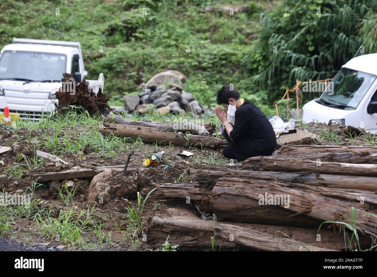 A woman prays silently for the victims of 2020 Kyushu floods in Tsunagi Town, Kumamoto ...