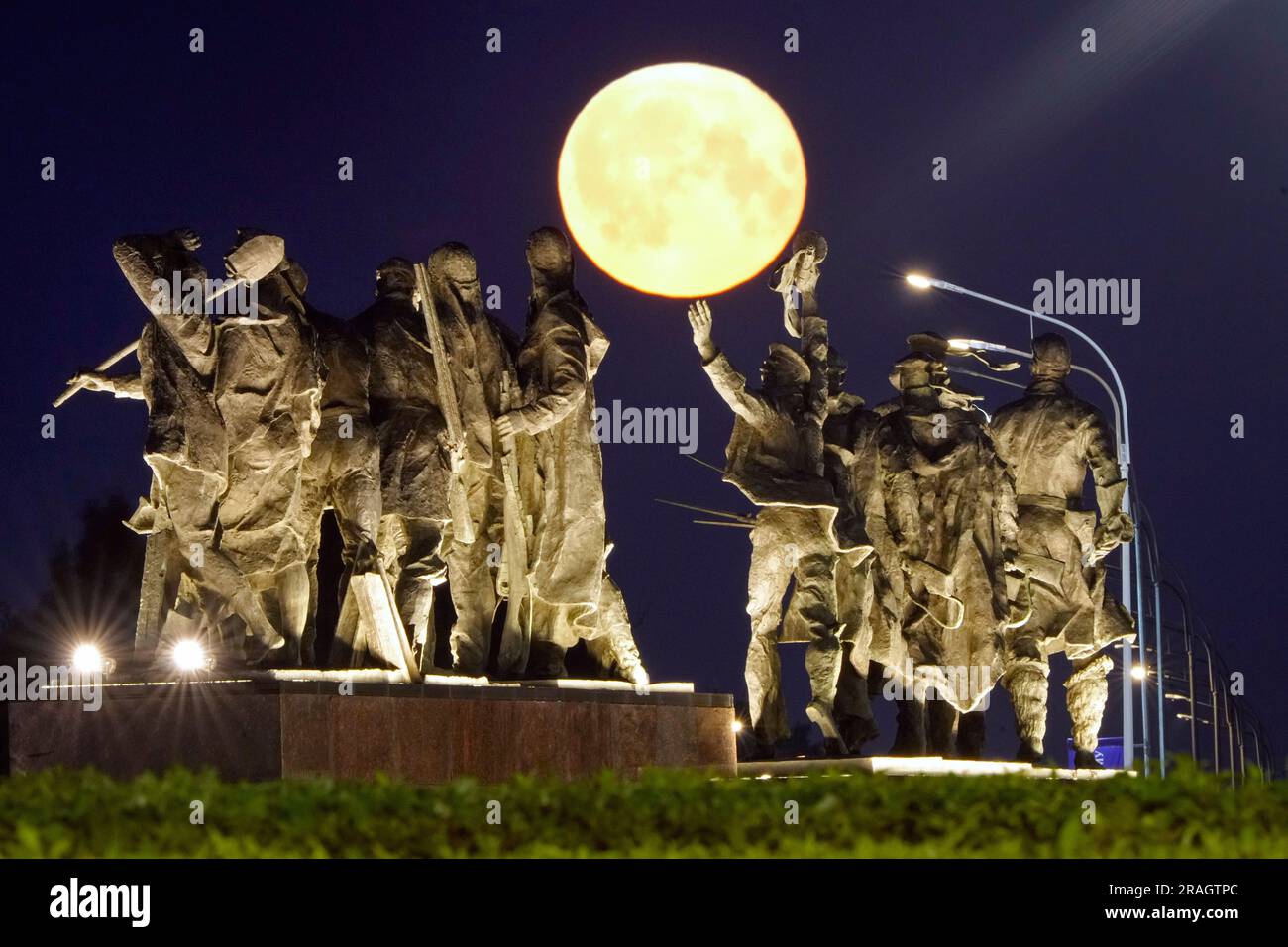 A super moon rises behind a Soviet-era monument for defenders of ...