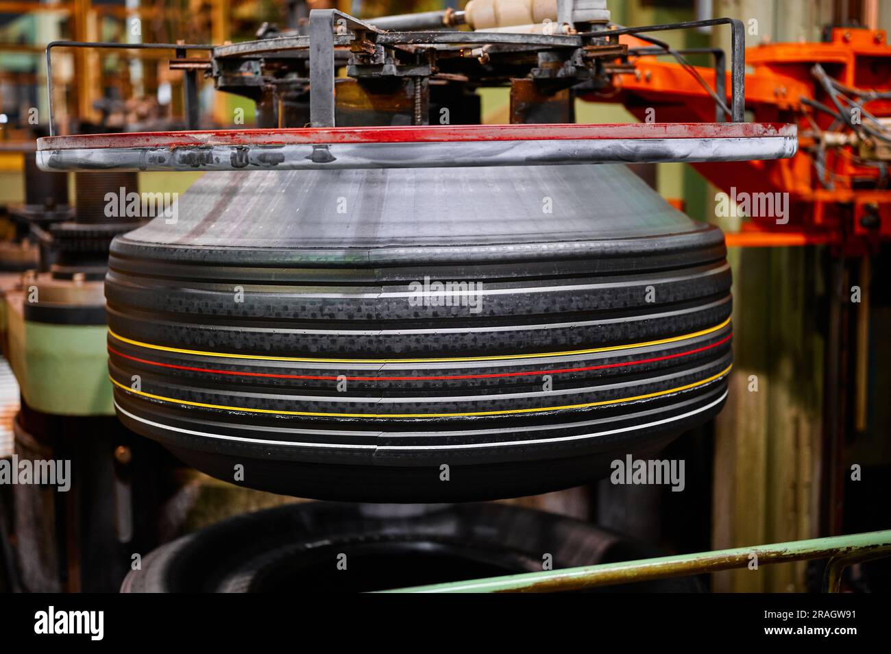 Automatic manipulators carry raw tire to vulcanization press Stock ...