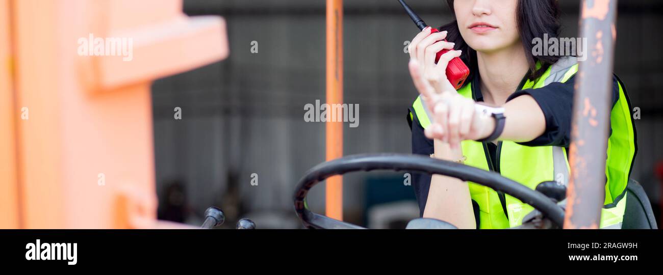 Young asian woman is foreman using radio for communication while ...