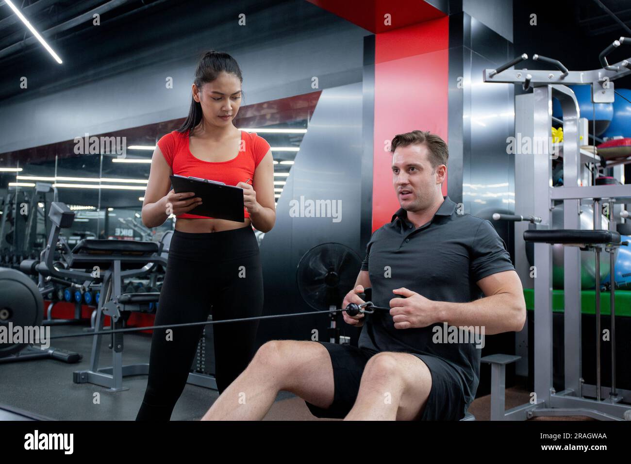 Coach woman guiding workout with hands muscles stretch with equipment ...