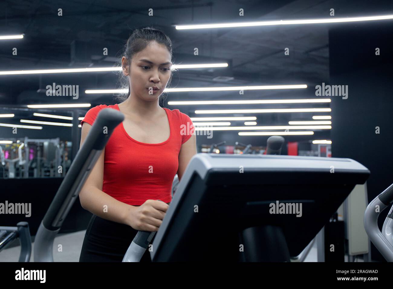 Portrait young asian woman walking on treadmill in fitness gym, cardio ...