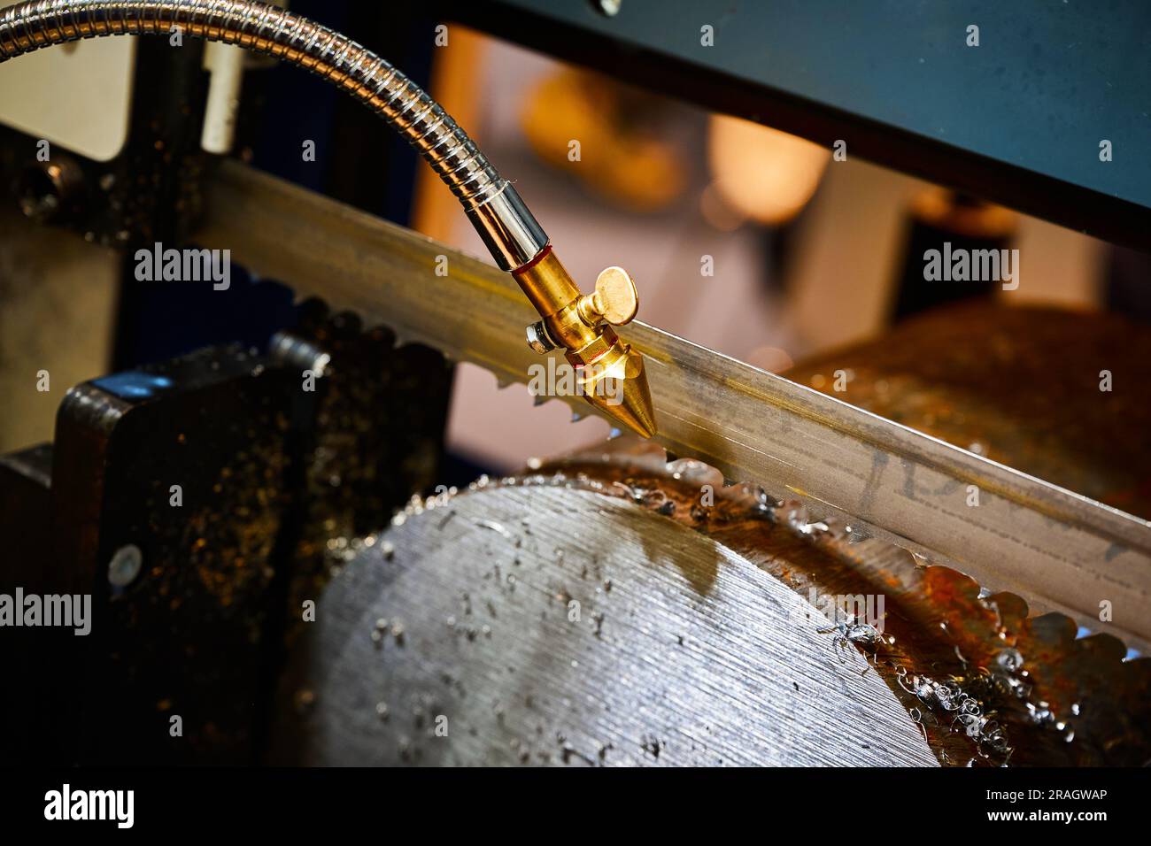 Cutting metal casting with band saw machine at plant Stock Photo - Alamy