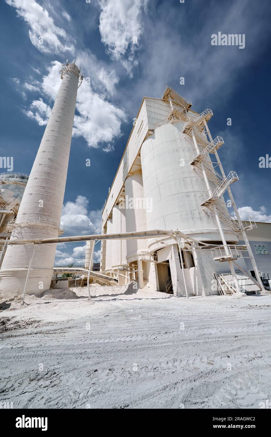 Concrete silos for limestone storage under cloudy sky Stock Photo - Alamy