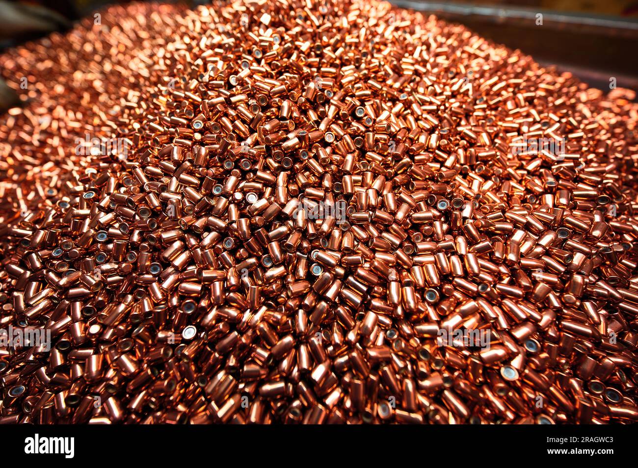 Brass metal bullets pile for weapons as background Stock Photo - Alamy
