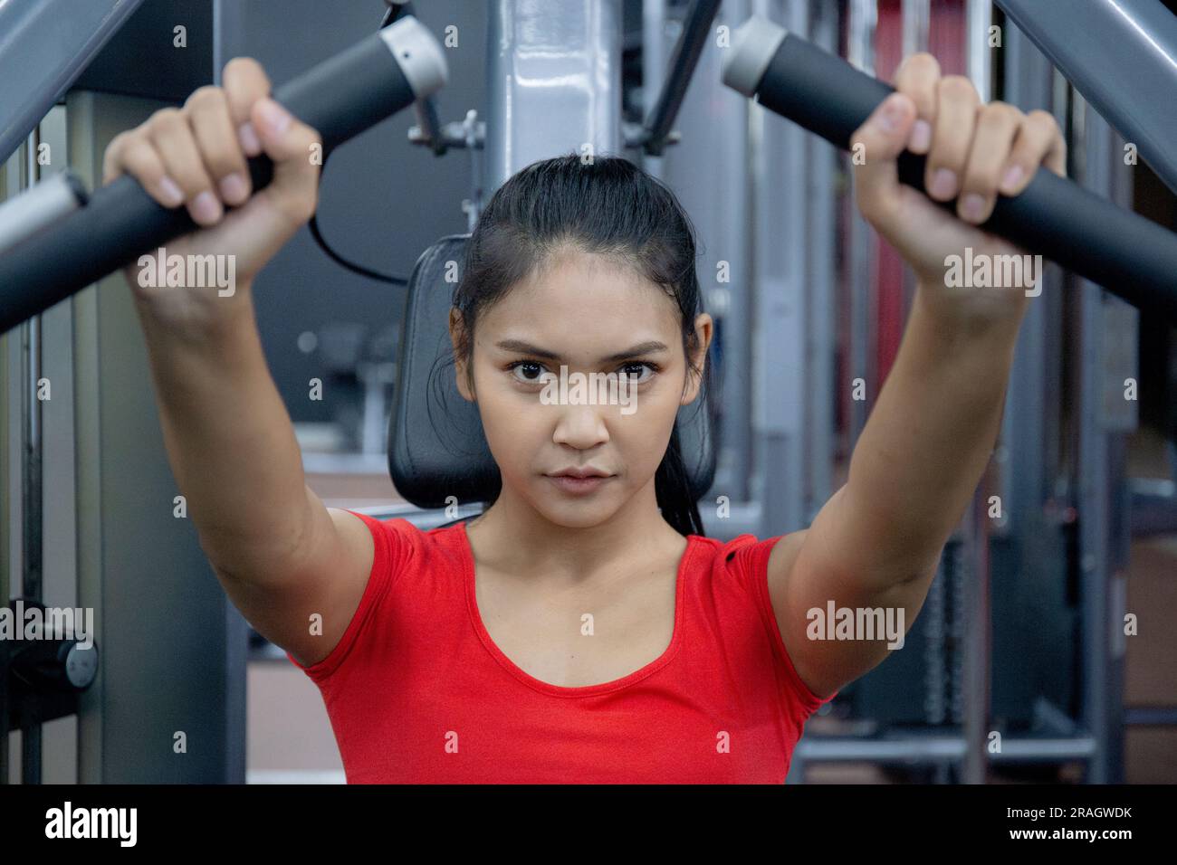 Young asian woman workout with strength training and determination with ...