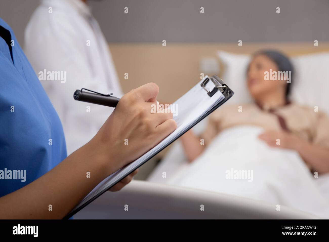 Nurse check and writing document on clipboard with elderly patient in ...
