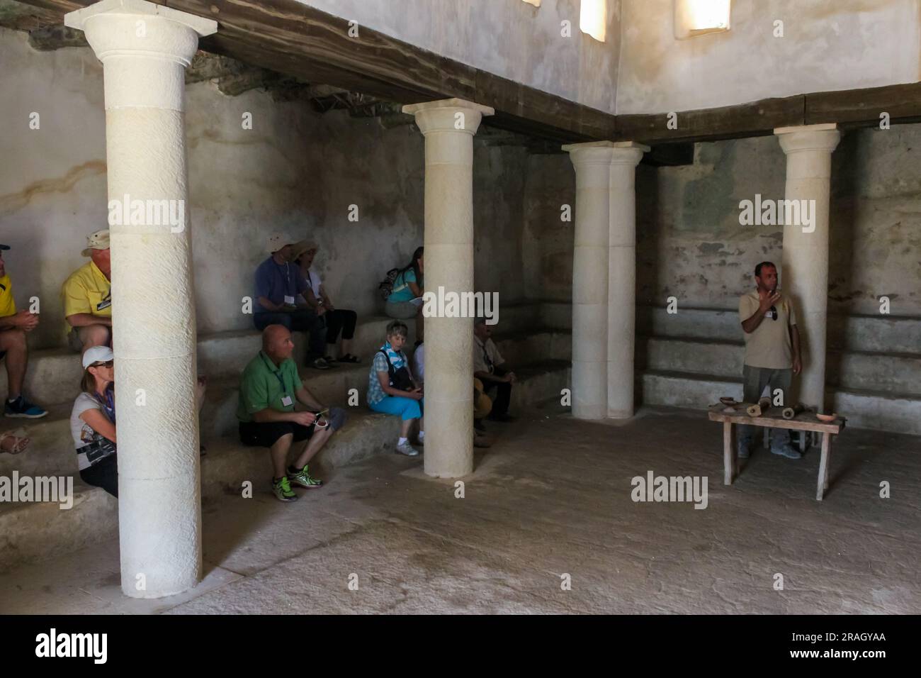 A tour guide speaks to a tour group in a synagogue in the Nazareth ...