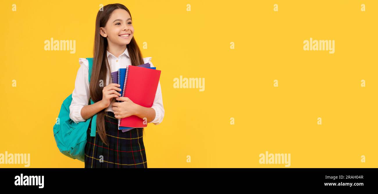 happy child with backpack and workbook in school uniform full length on ...