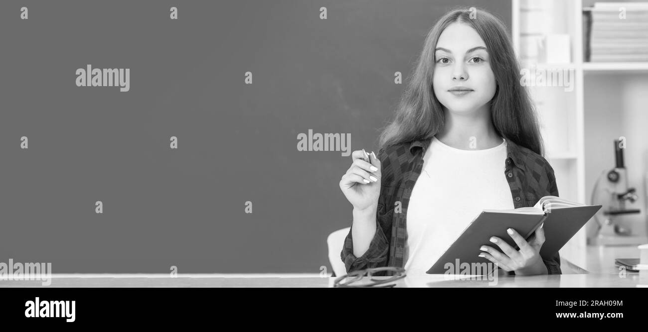 smiling child making notes in notebook. back to school. teen girl ready ...