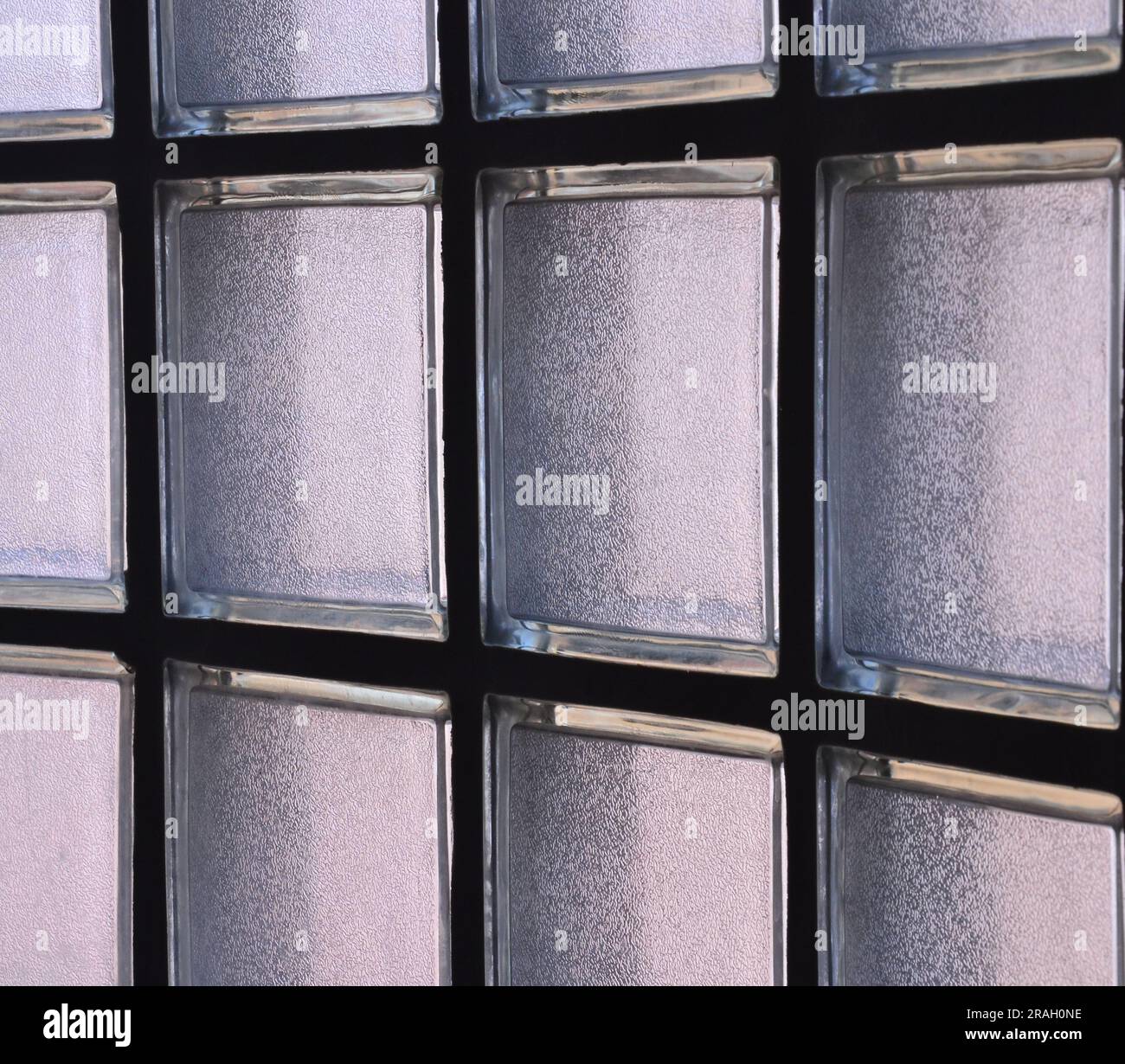 Abstract pattern of squares of frosted glass in a window which prevents ...